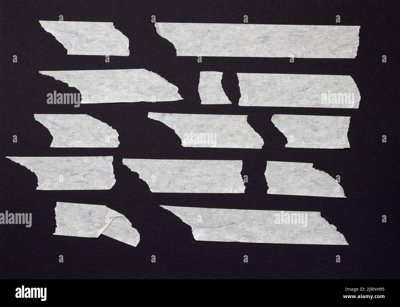A black background with cut paper tapes Stock Photo - Alamy