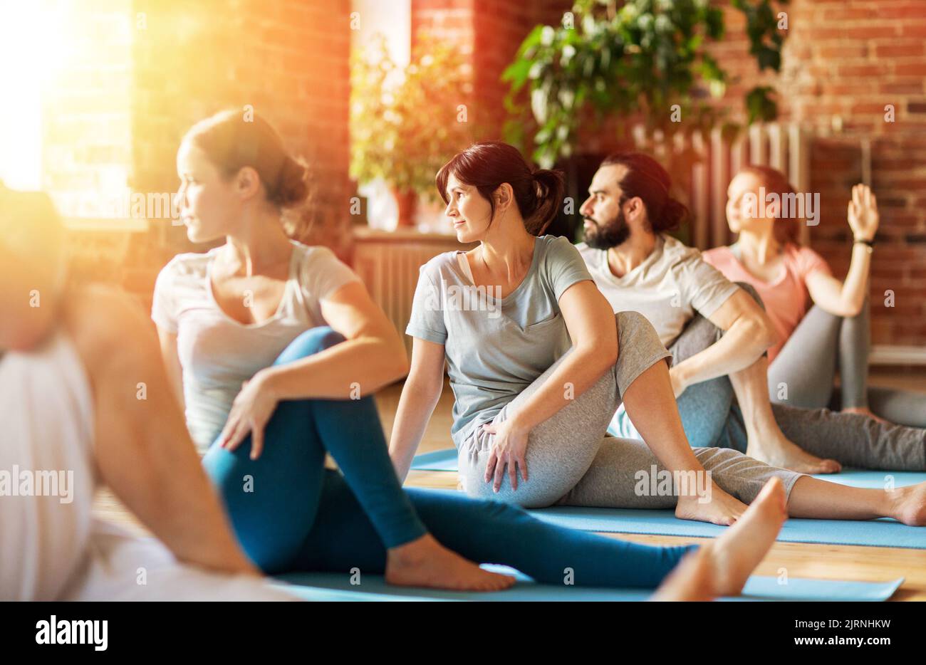 group of people doing yoga exercises at studio Stock Photo - Alamy