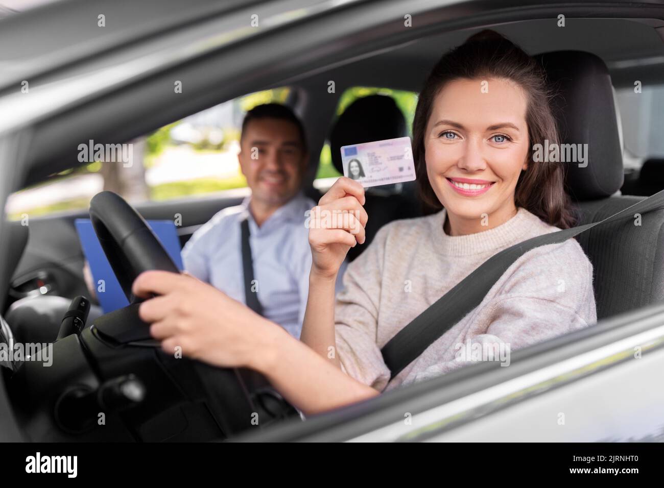 car driving instructor and driver with license Stock Photo - Alamy