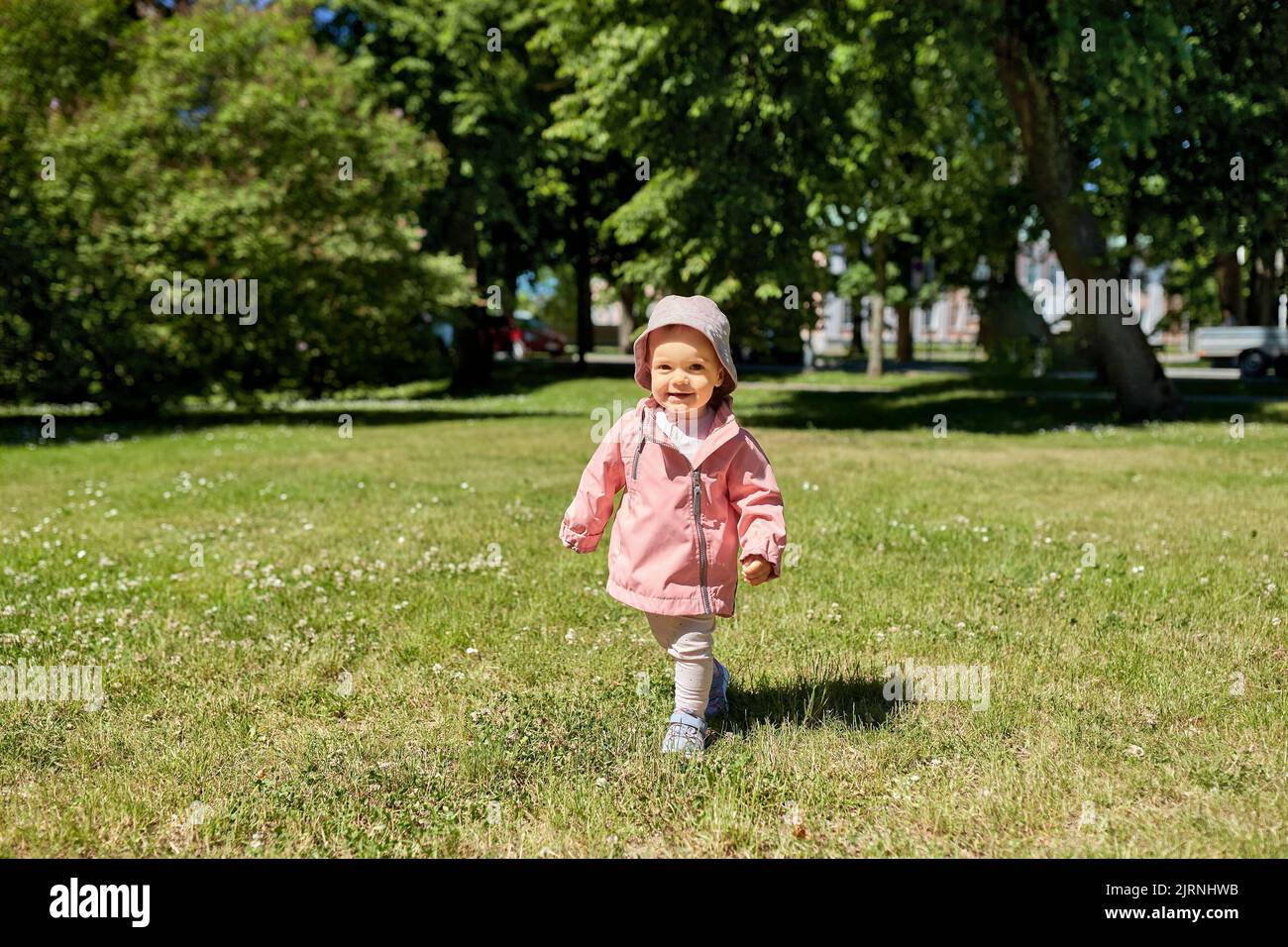 happy little baby girl walking in summer park Stock Photo - Alamy