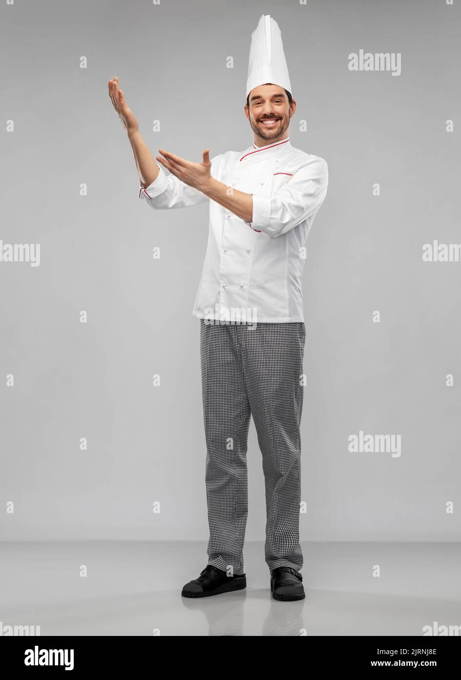 happy smiling male chef showing something Stock Photo - Alamy
