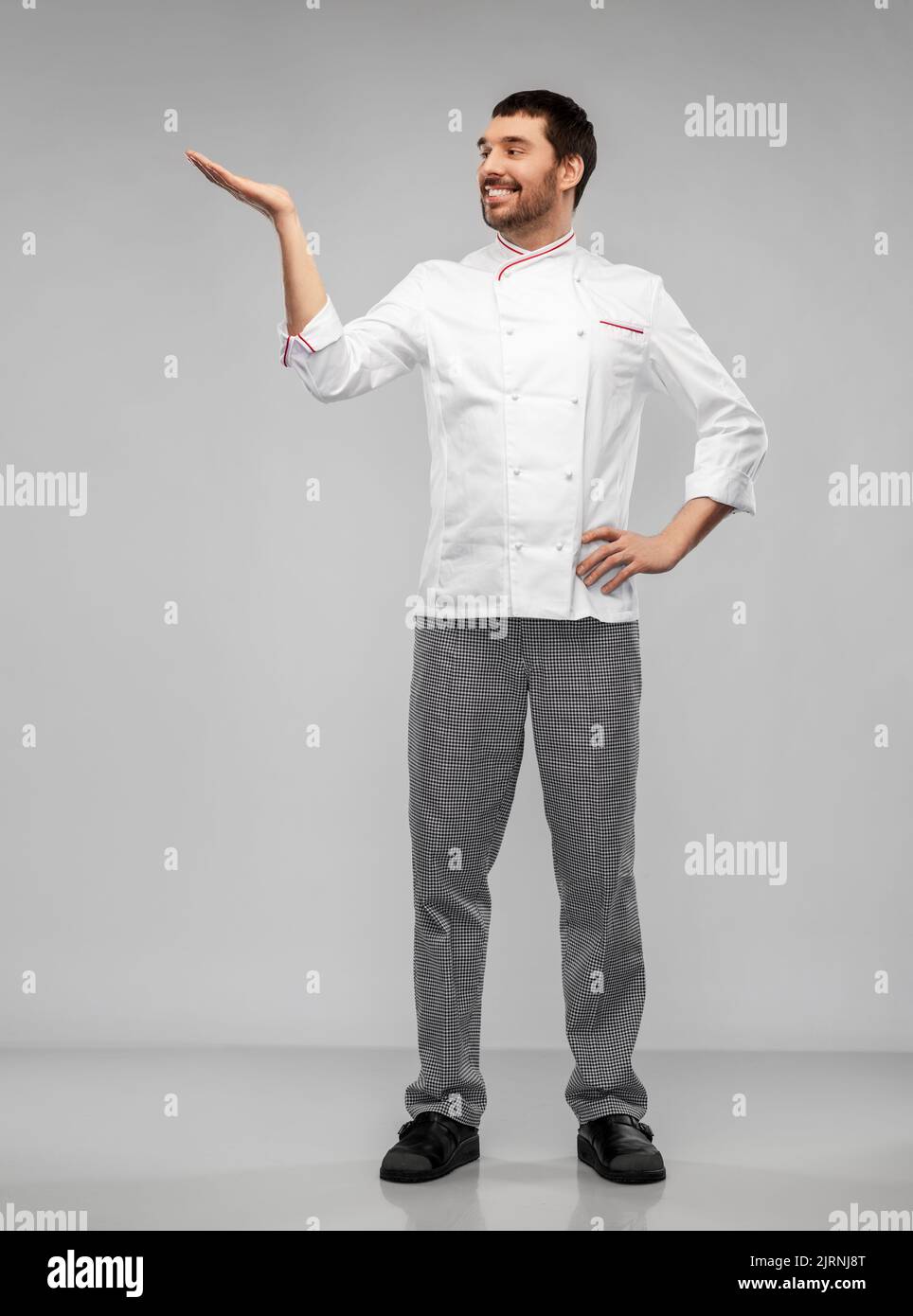 happy smiling male chef holding something on hand Stock Photo - Alamy