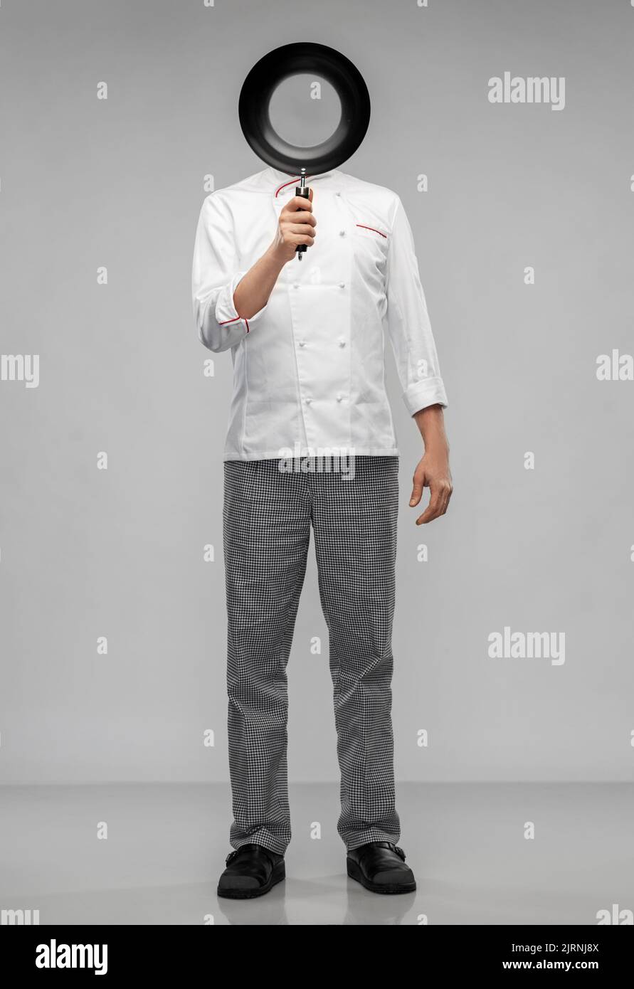 male chef hiding his face over frying pan Stock Photo - Alamy