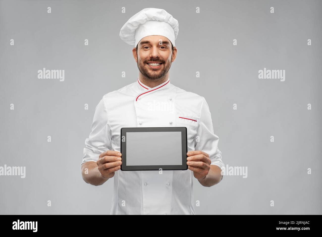 happy smiling male chef showing tablet pc computer Stock Photo - Alamy
