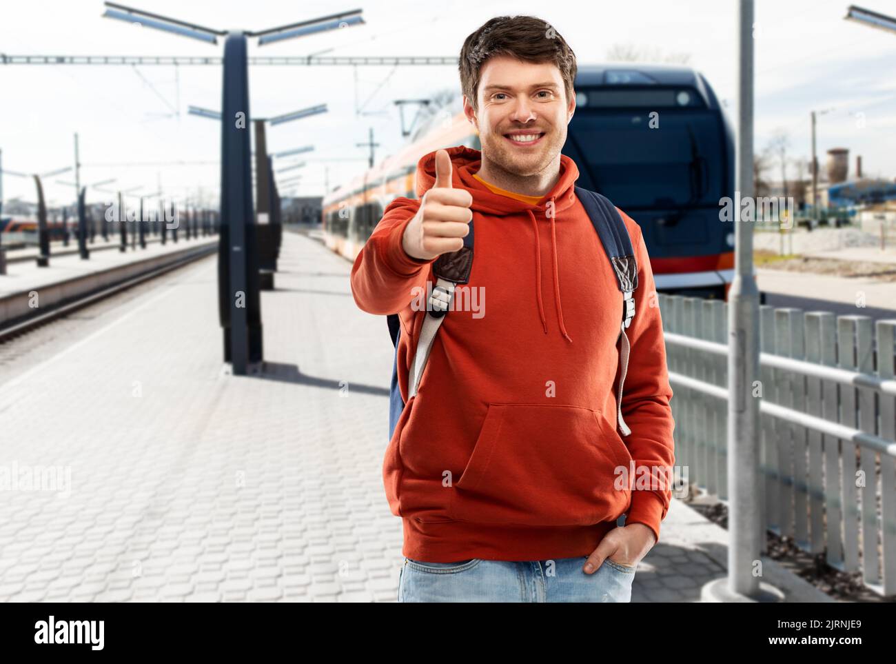 man traveling by train and showing thumbs up Stock Photo - Alamy