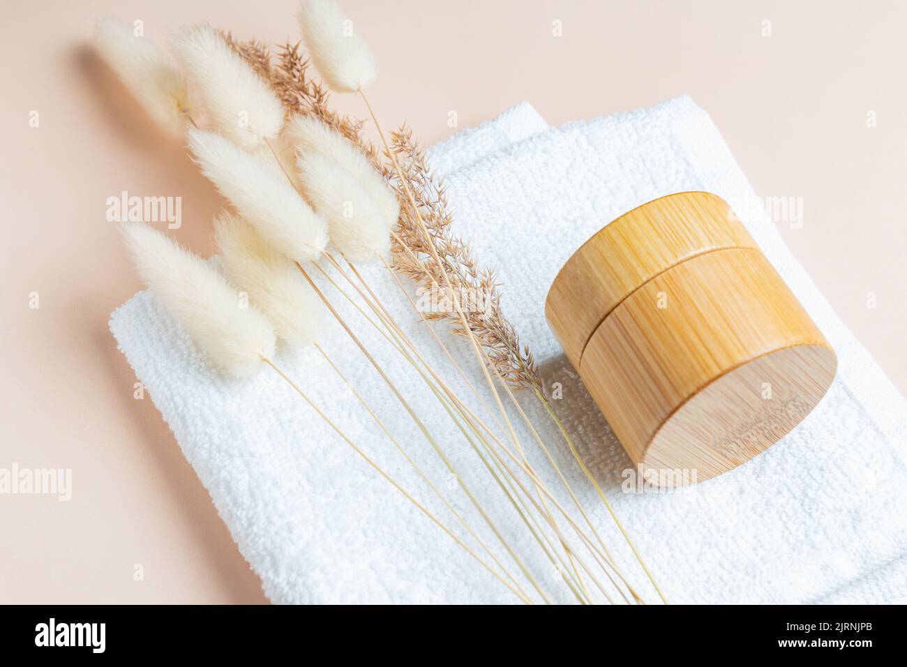 Natural moisturising or collagen gel in bamboo jar on white cotton on ...