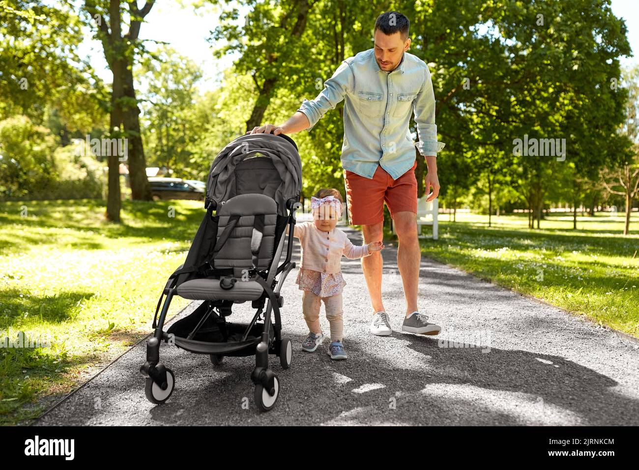 happy father with child in stroller at summer park Stock Photo - Alamy