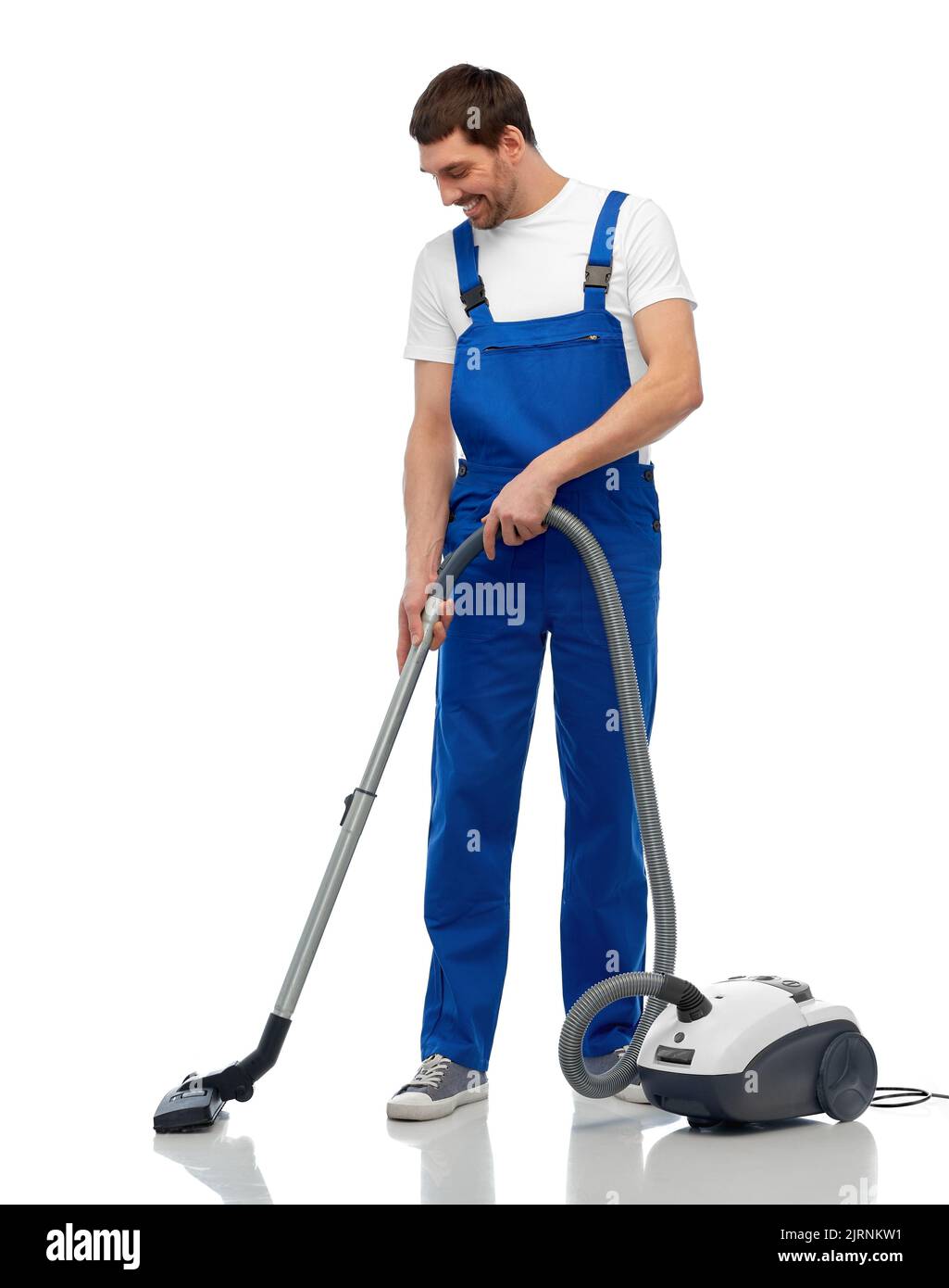 male worker cleaning floor with vacuum cleaner Stock Photo - Alamy
