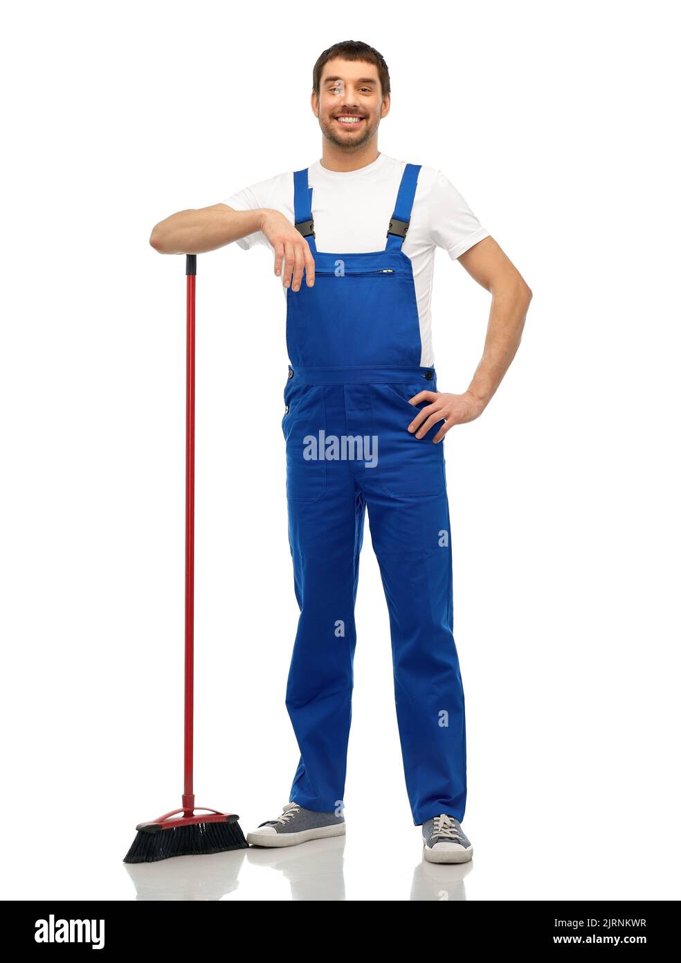 male cleaner in overall cleaning floor with broom Stock Photo - Alamy