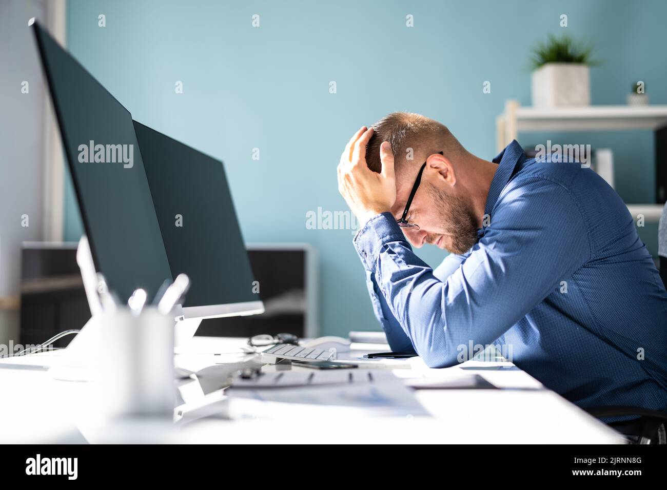 Stressed Sick Employee Man At Computer With Pain Stock Photo - Alamy