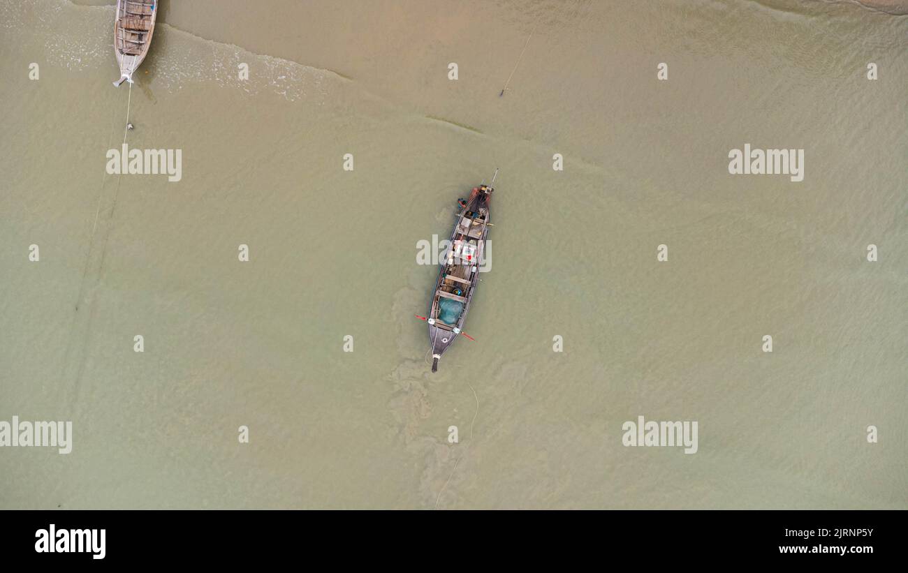 Aerial view from drones of fishing boats in the shore during low tide ...