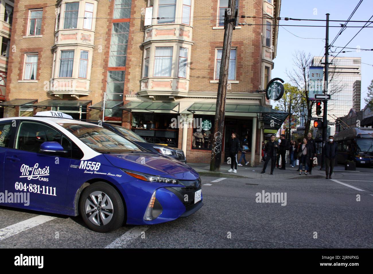 A blue taxi in downtown Vancouver, British Columbia, Canada Stock Photo ...