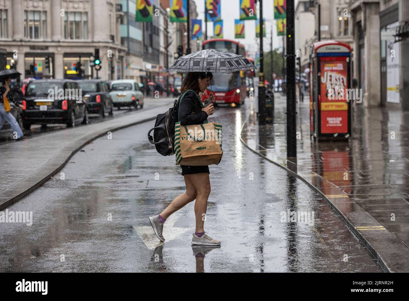 Commuters and tourists brave the torrential summer rain showers on ...