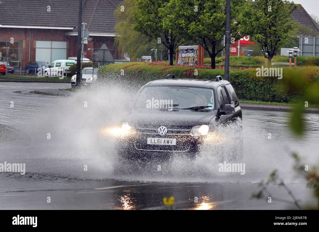 A MOTORIST GETS DRIVES THROUGH FLOODWATER ON A ROUNDABOUT ON THE A27 AT ...