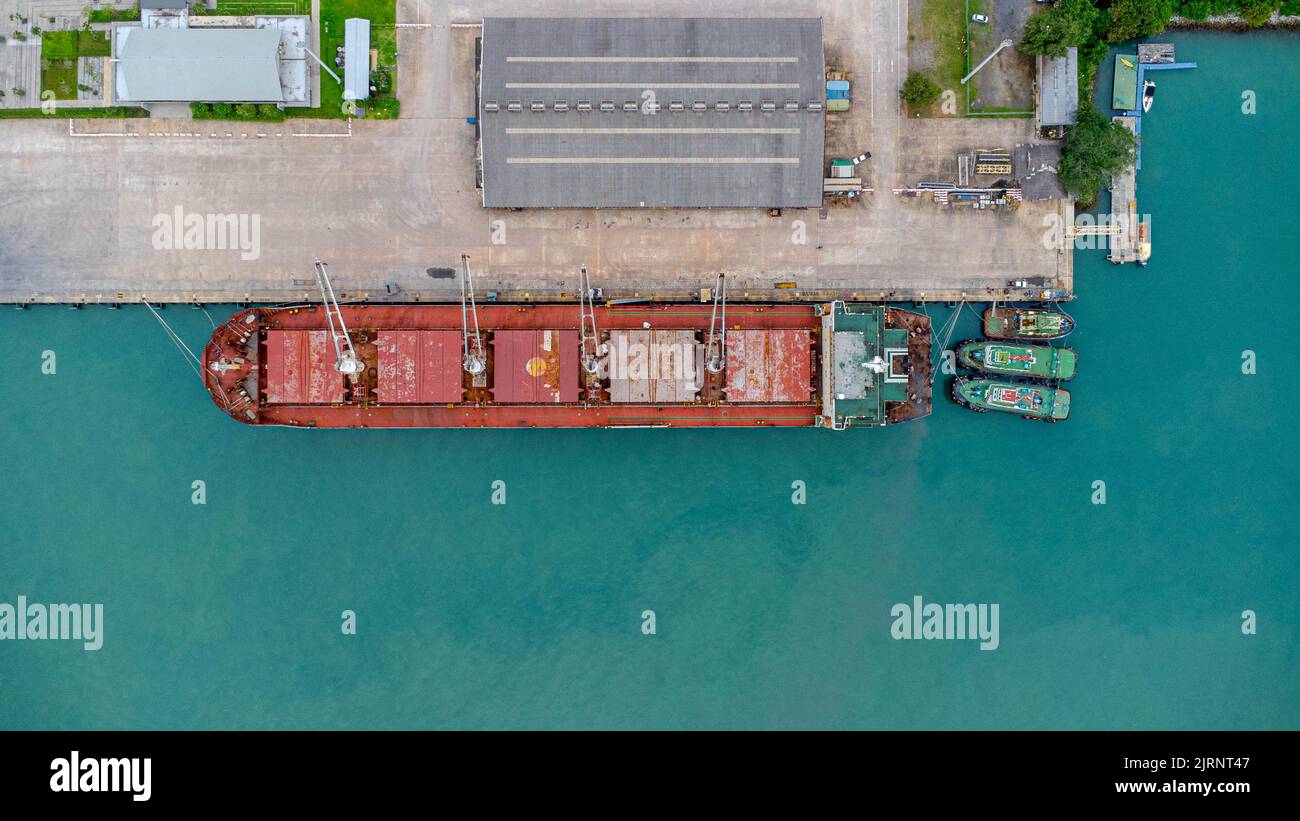 Aerial view from drone of commercial ship with cranes while unloading ...