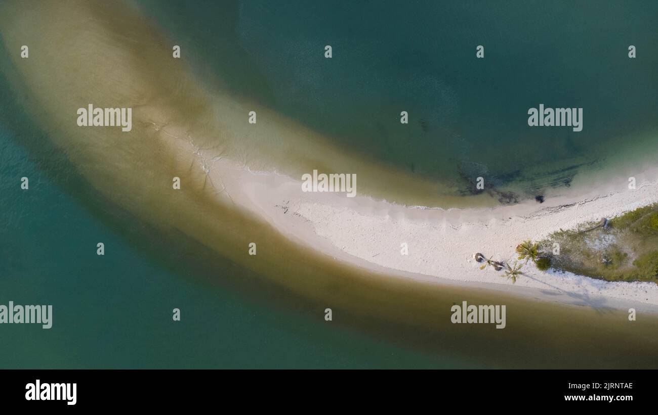Sandy beach jutting out into the middle of the sea with beautiful water ...