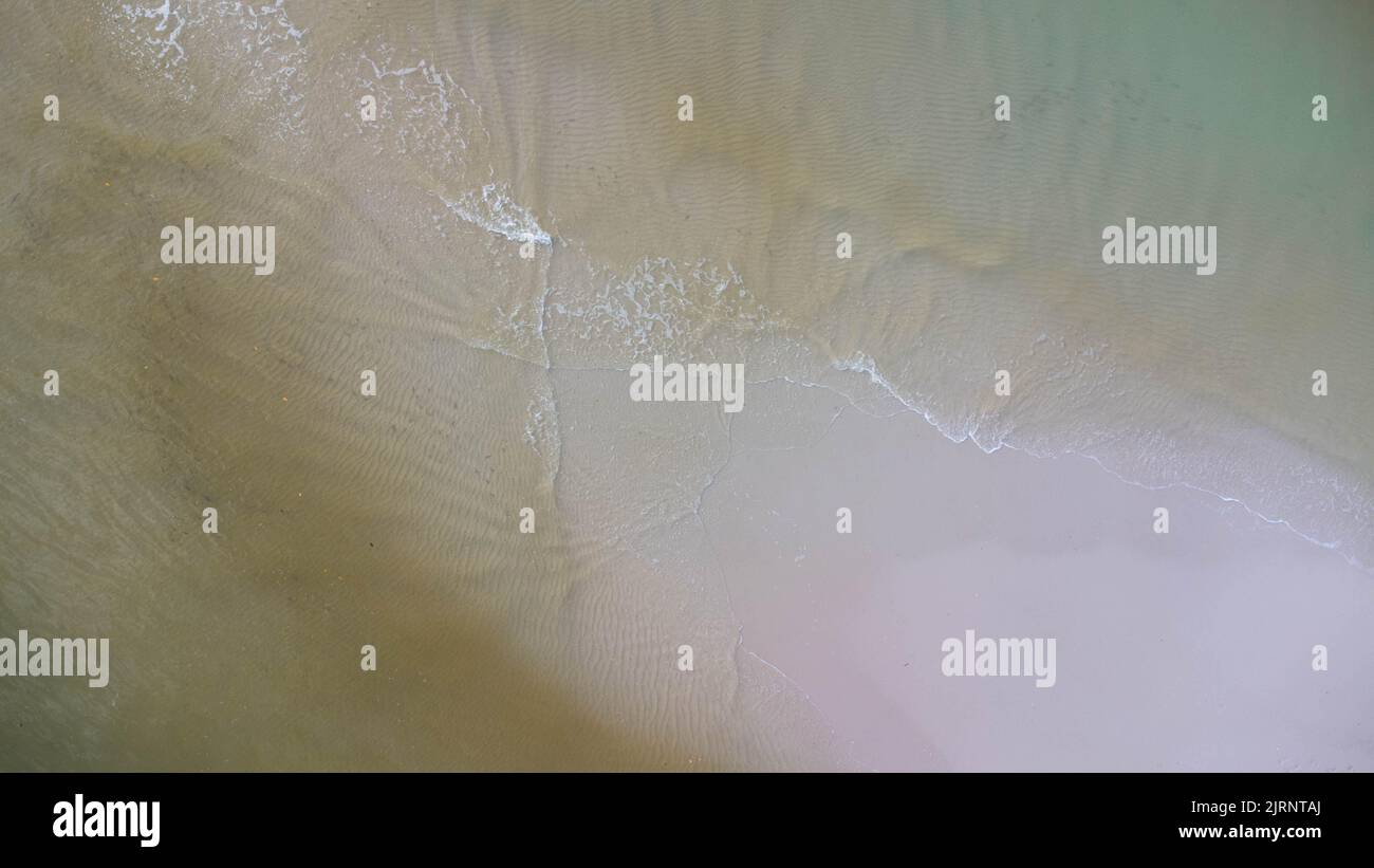 Sandy beach jutting out into the middle of the sea with beautiful water ...