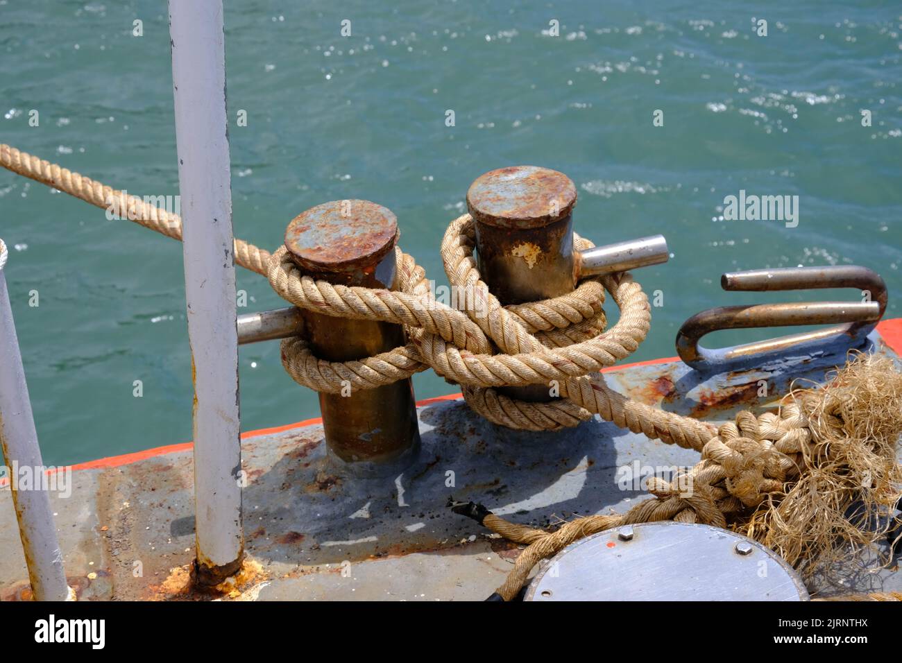 Close up of ropes and rusty bollard. rope and Marina bollard on moorage ...