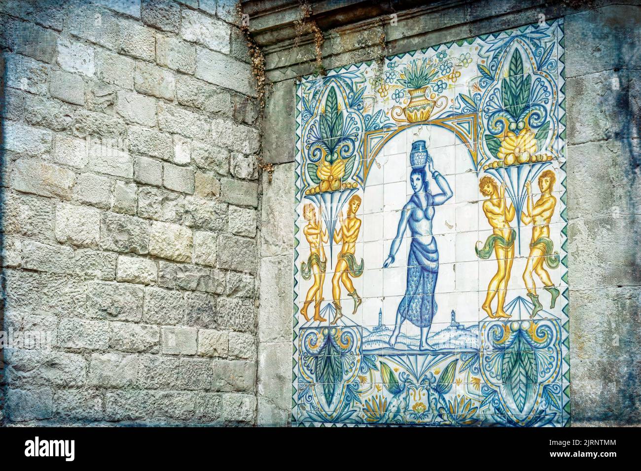 A tile work of art decorating a corner between two medieval stone walls ...