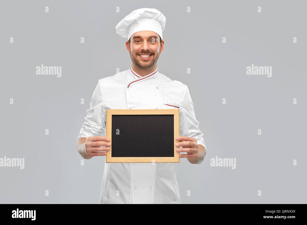 happy smiling male chef showing chalkboard Stock Photo - Alamy