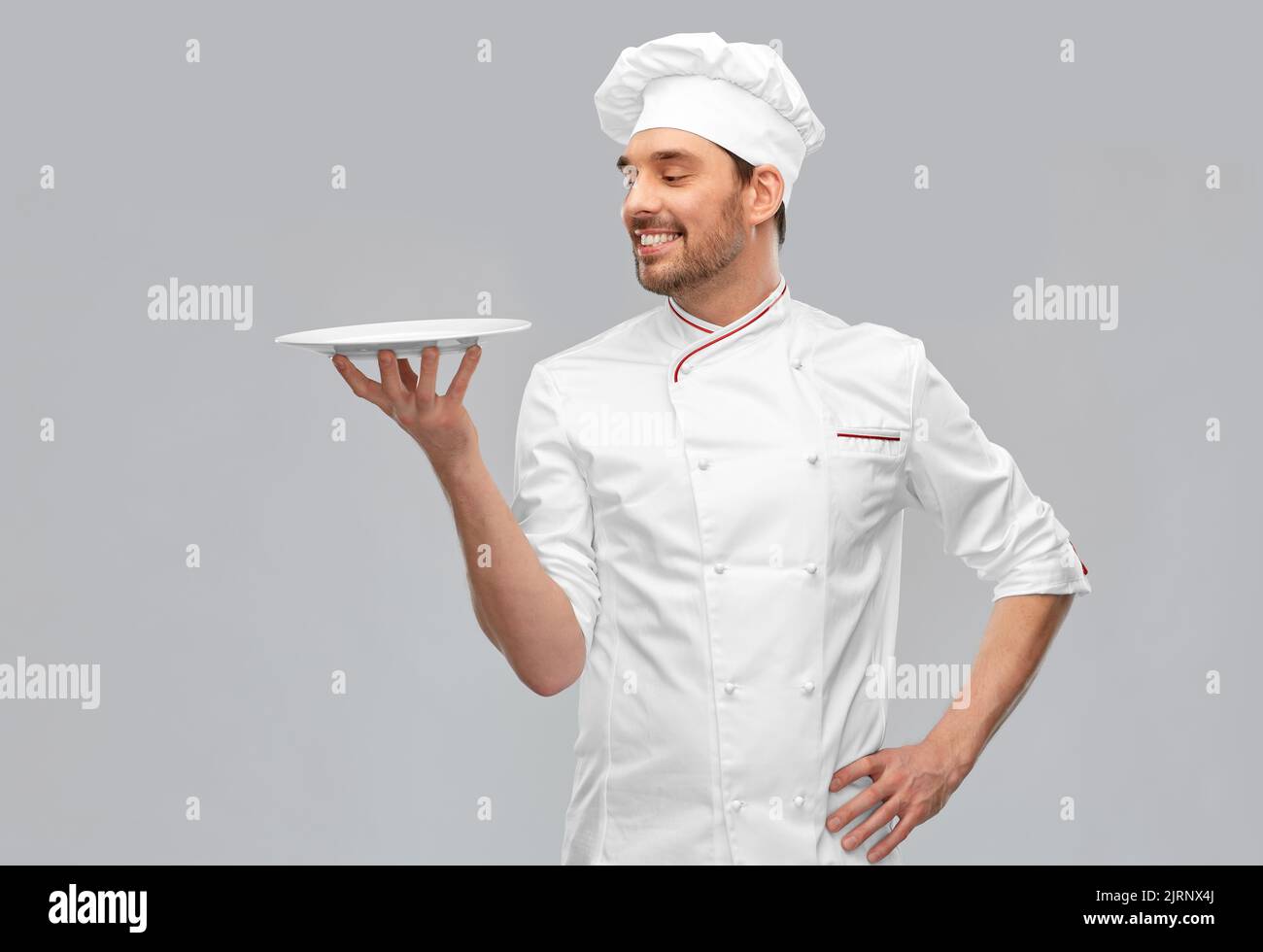 happy smiling male chef holding empty plate Stock Photo - Alamy