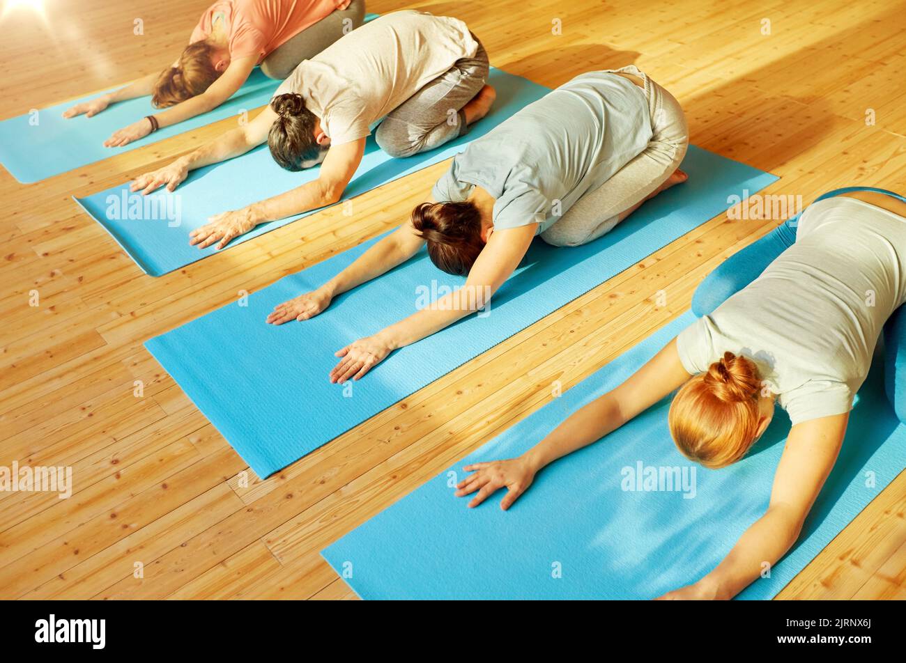 group of people doing yoga exercises at studio Stock Photo - Alamy