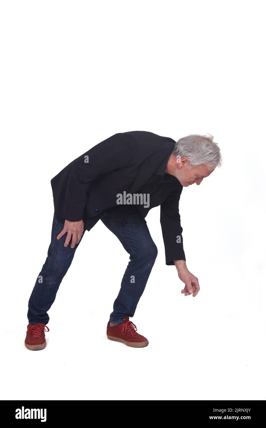 man who is crowching to look for something on the ground Stock Photo ...