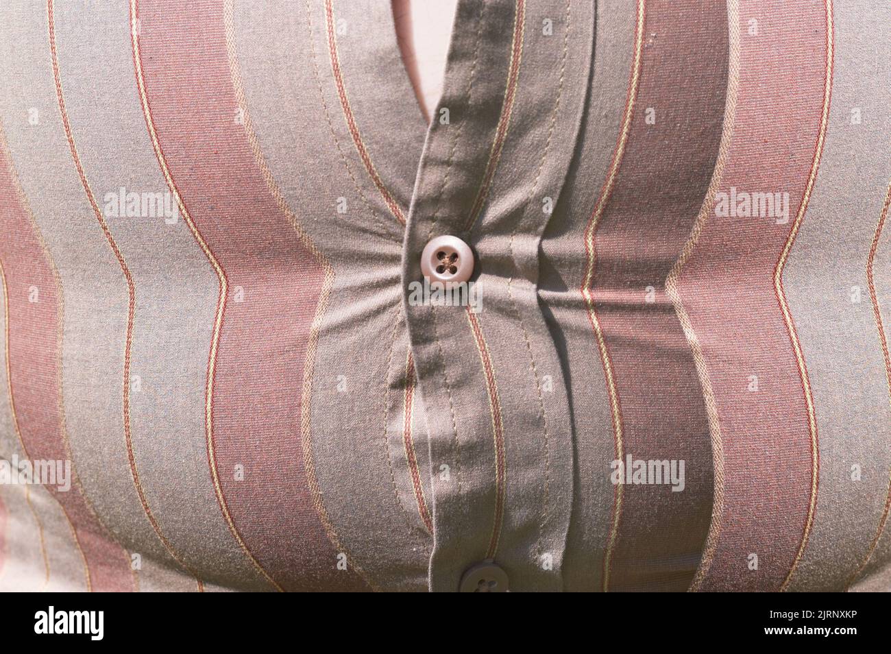 Fastened shirt over a fat male stomach close up Stock Photo - Alamy