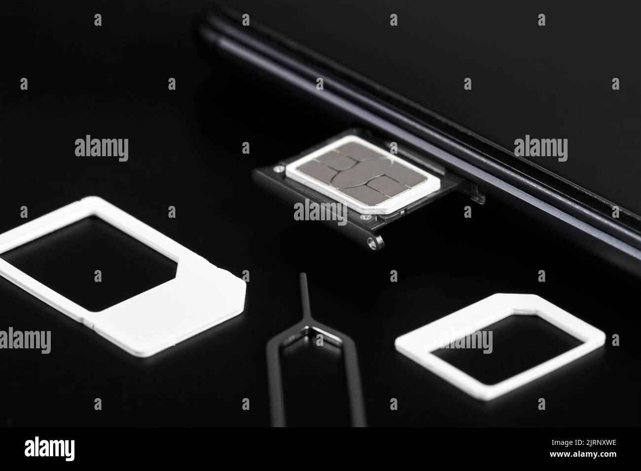 SIM card inserted into the sim card tray of a smartphone with pin ...