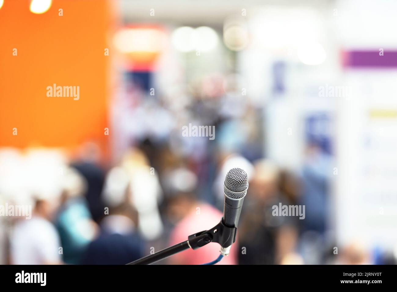 Microphone in focus against blurred people. Public speaking concept ...