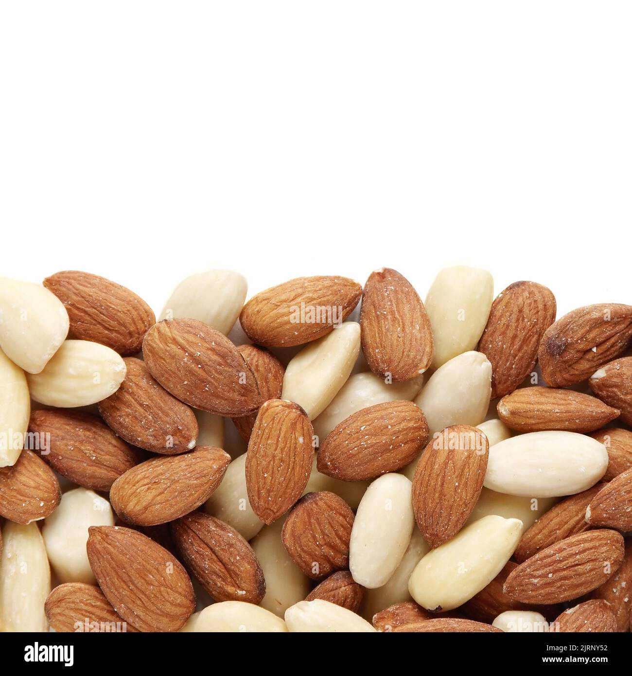 Mixed almond nuts scattered on white background Stock Photo - Alamy