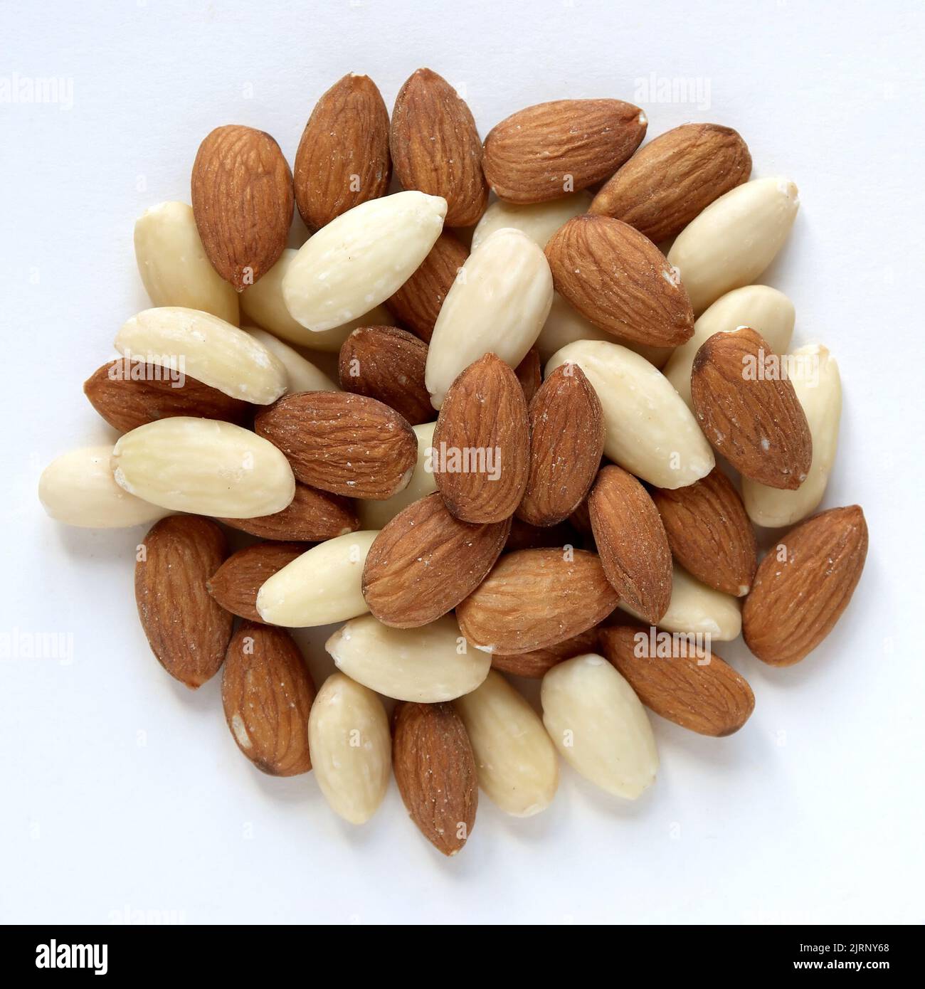 A pile of mixed almond nuts on white background Stock Photo - Alamy