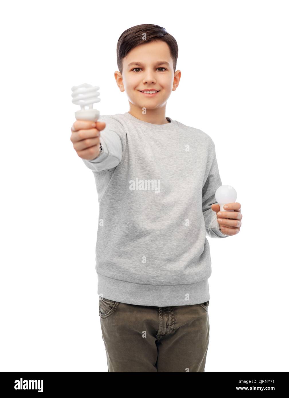 smiling boy comparing different light bulbs Stock Photo - Alamy