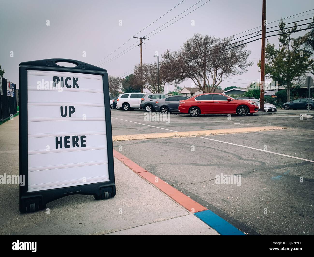 Pick up here sign in front of school Stock Photo - Alamy