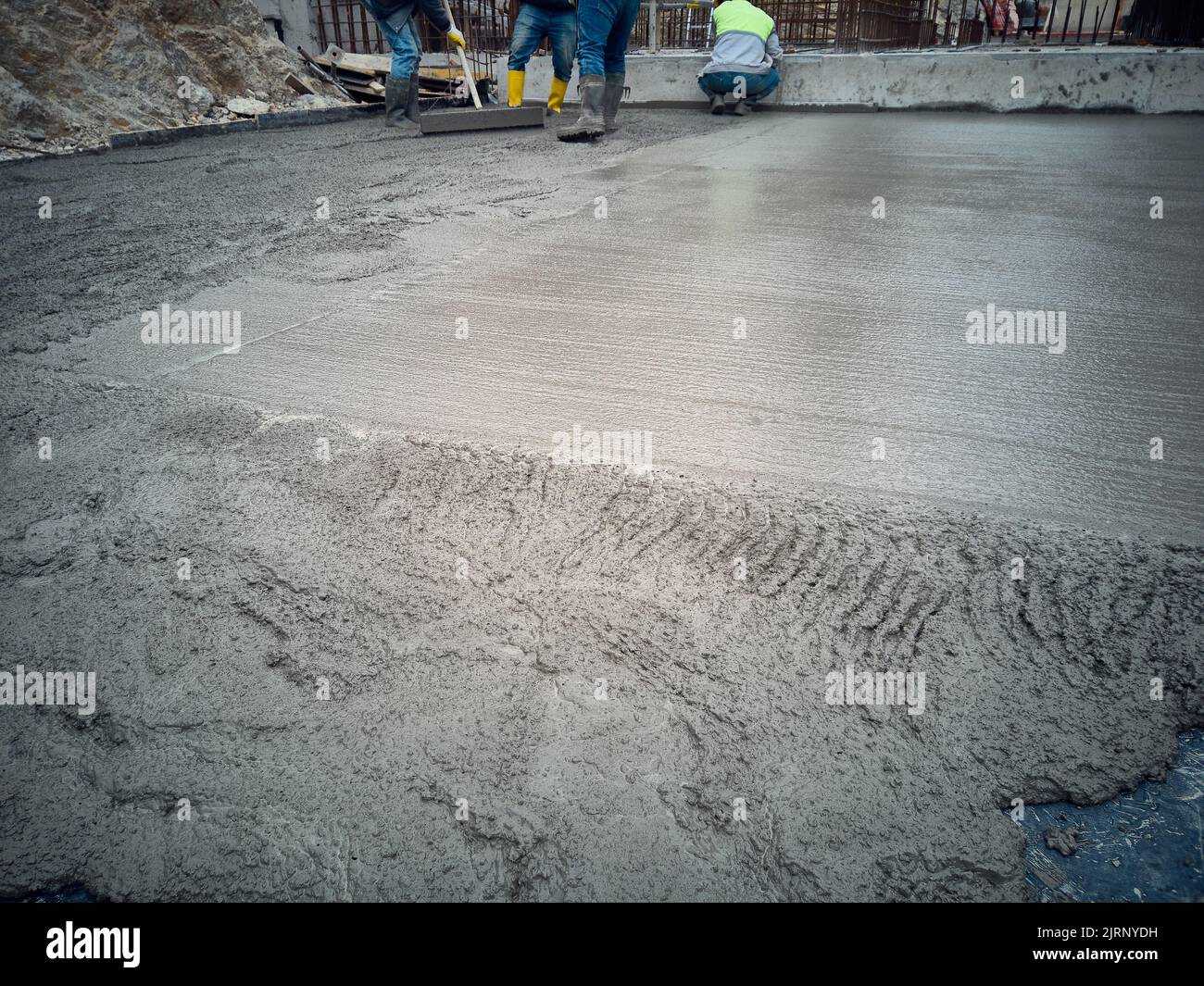 Construction worker levels wet concrete hi-res stock photography and ...