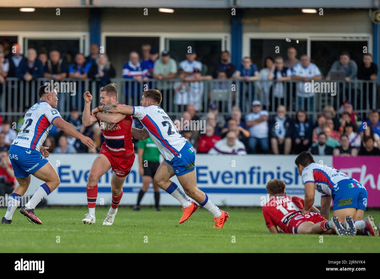 Rowan Milnes #21 of Hull KR is tackled by Yusuf Aydin #22 of Wakefield ...