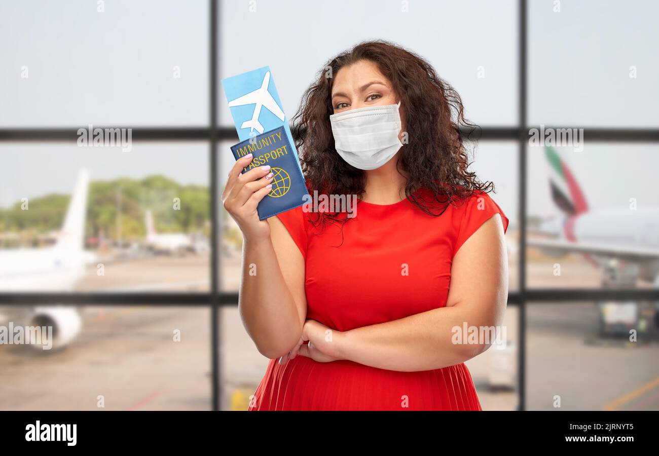 woman in mask with immunity passport and ticket Stock Photo - Alamy