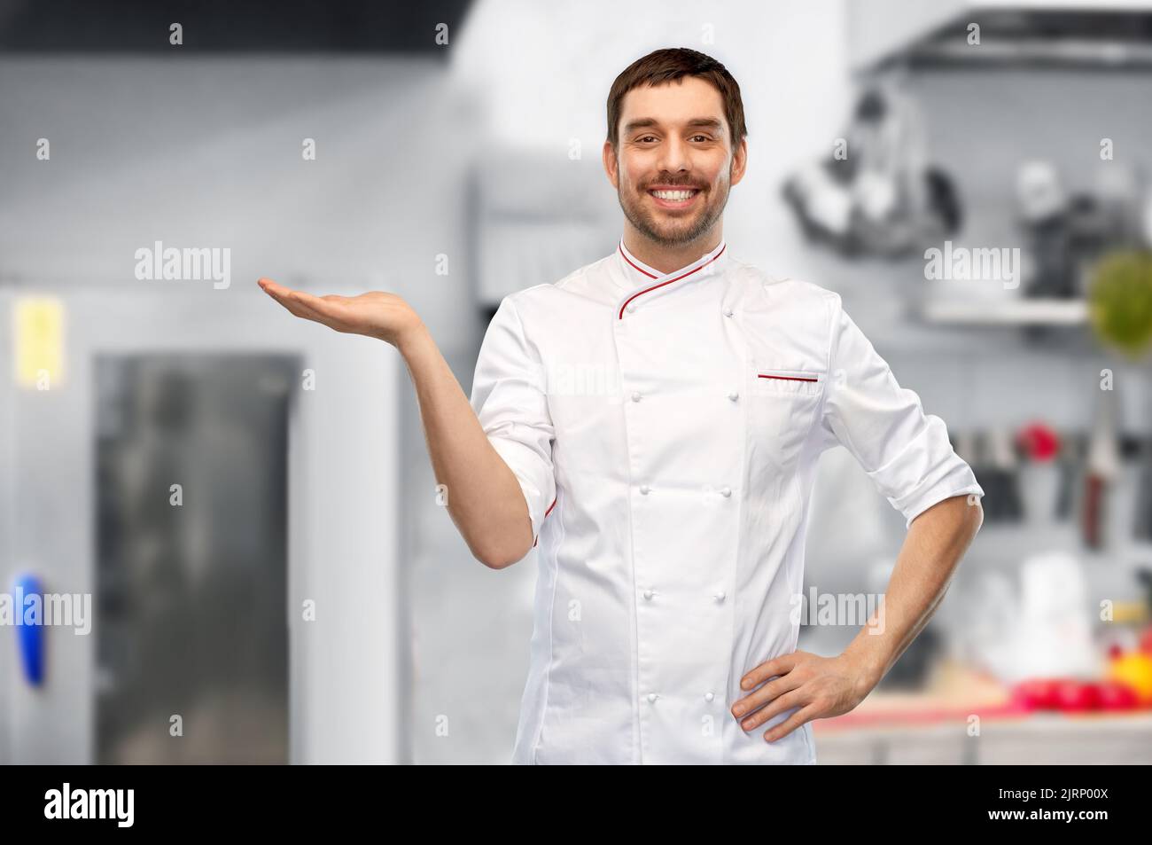 happy smiling male chef holding something on hand Stock Photo - Alamy