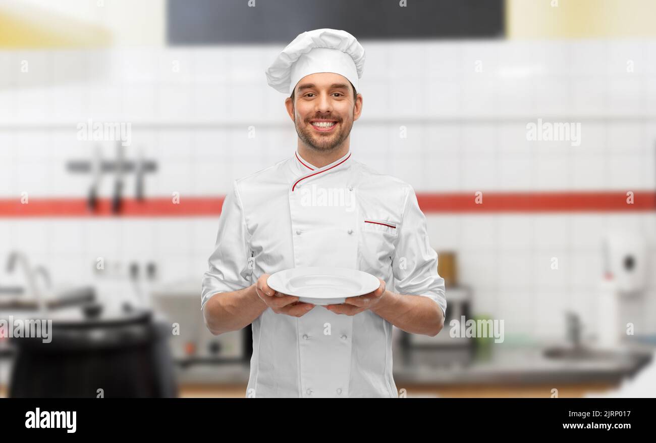 happy smiling male chef holding empty plate Stock Photo - Alamy