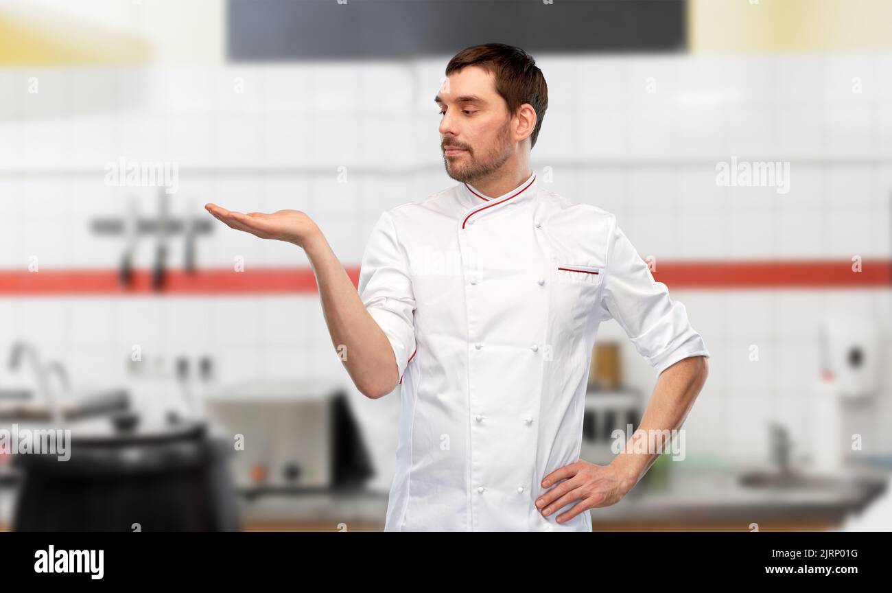 male chef holding something on hand Stock Photo - Alamy