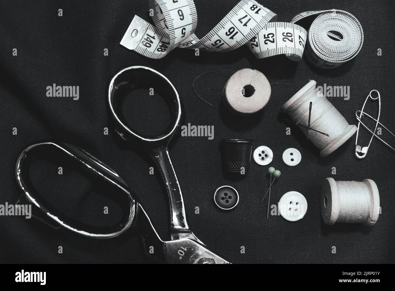 Retro tools for cutting and sewing. Needle with thread, thimble, sewing ...