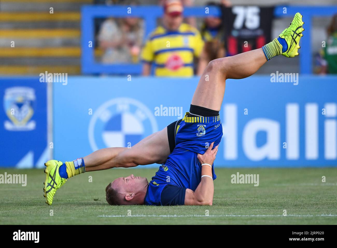 Jason Clark #14 of Warrington Wolves stretches during pre match warm up ...