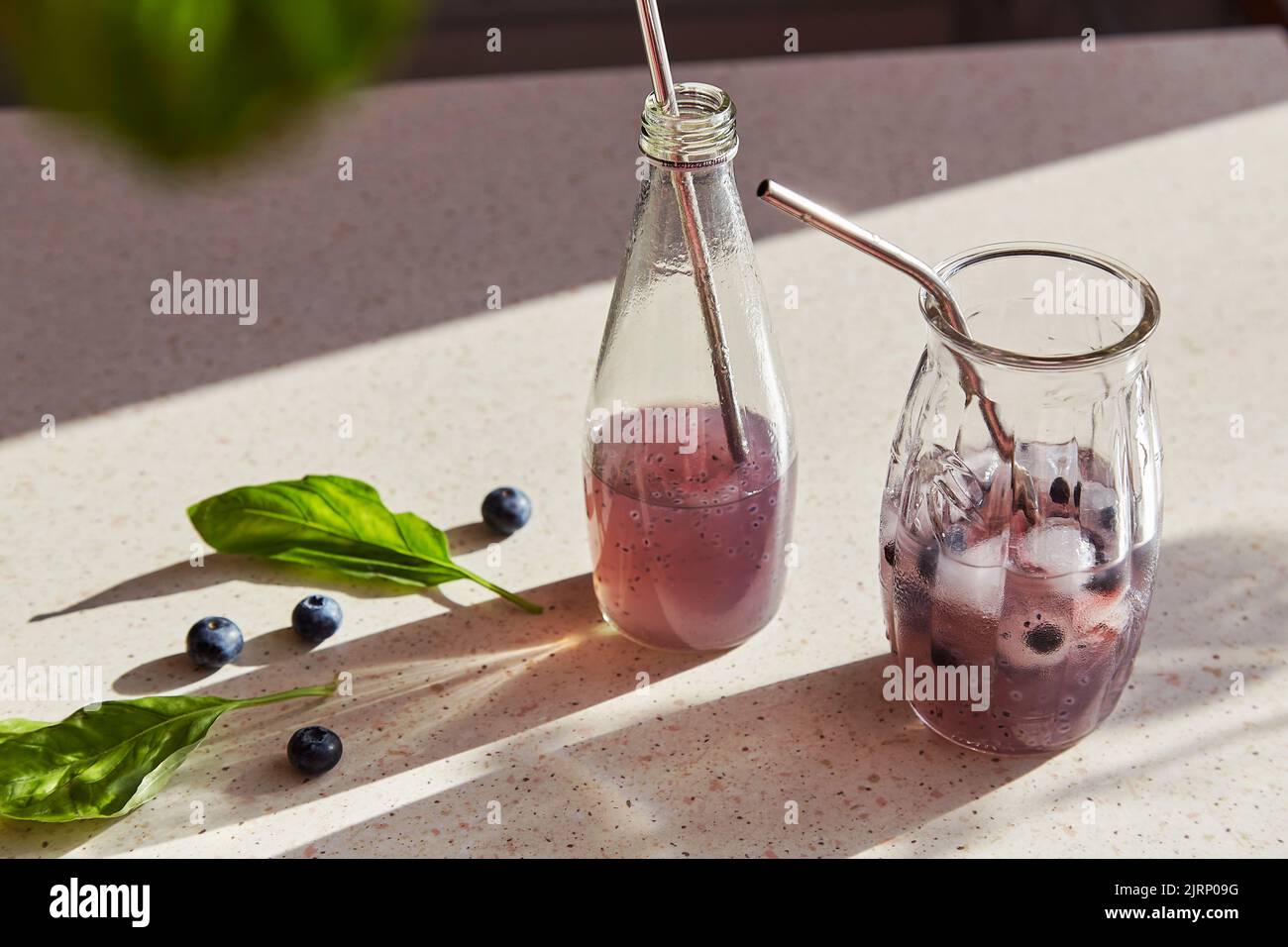 Natural summer herbal cocktail with blueberries, basil extract and ...