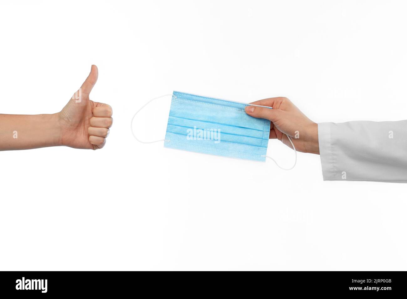 hand with mask and showing thumbs up Stock Photo - Alamy
