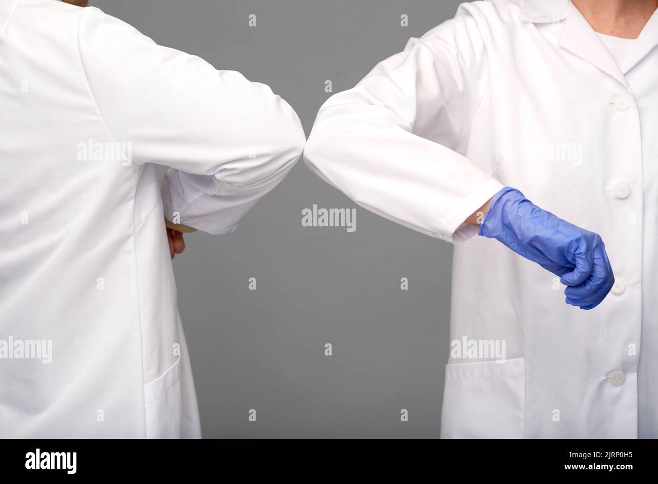 close up of doctors make elbow bump gesture Stock Photo - Alamy