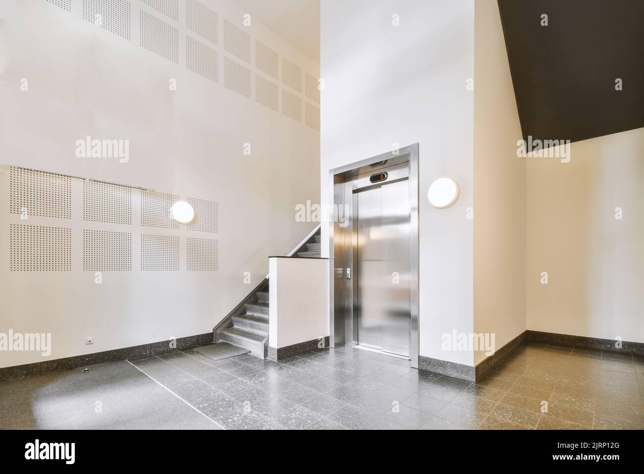 Shiny elevator with opened door located in illuminated hall of ...