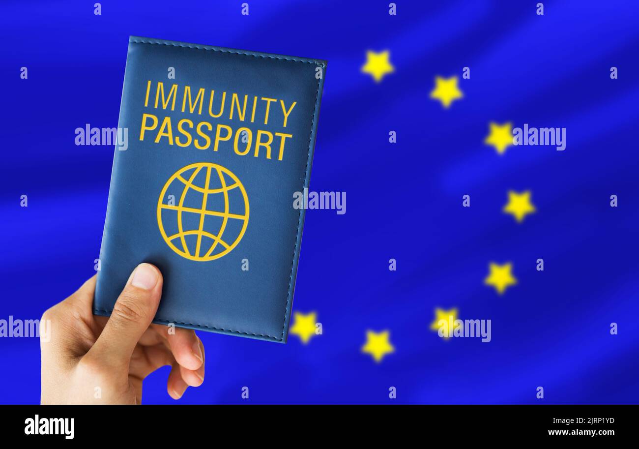 hand holding immunity passport over european union Stock Photo - Alamy