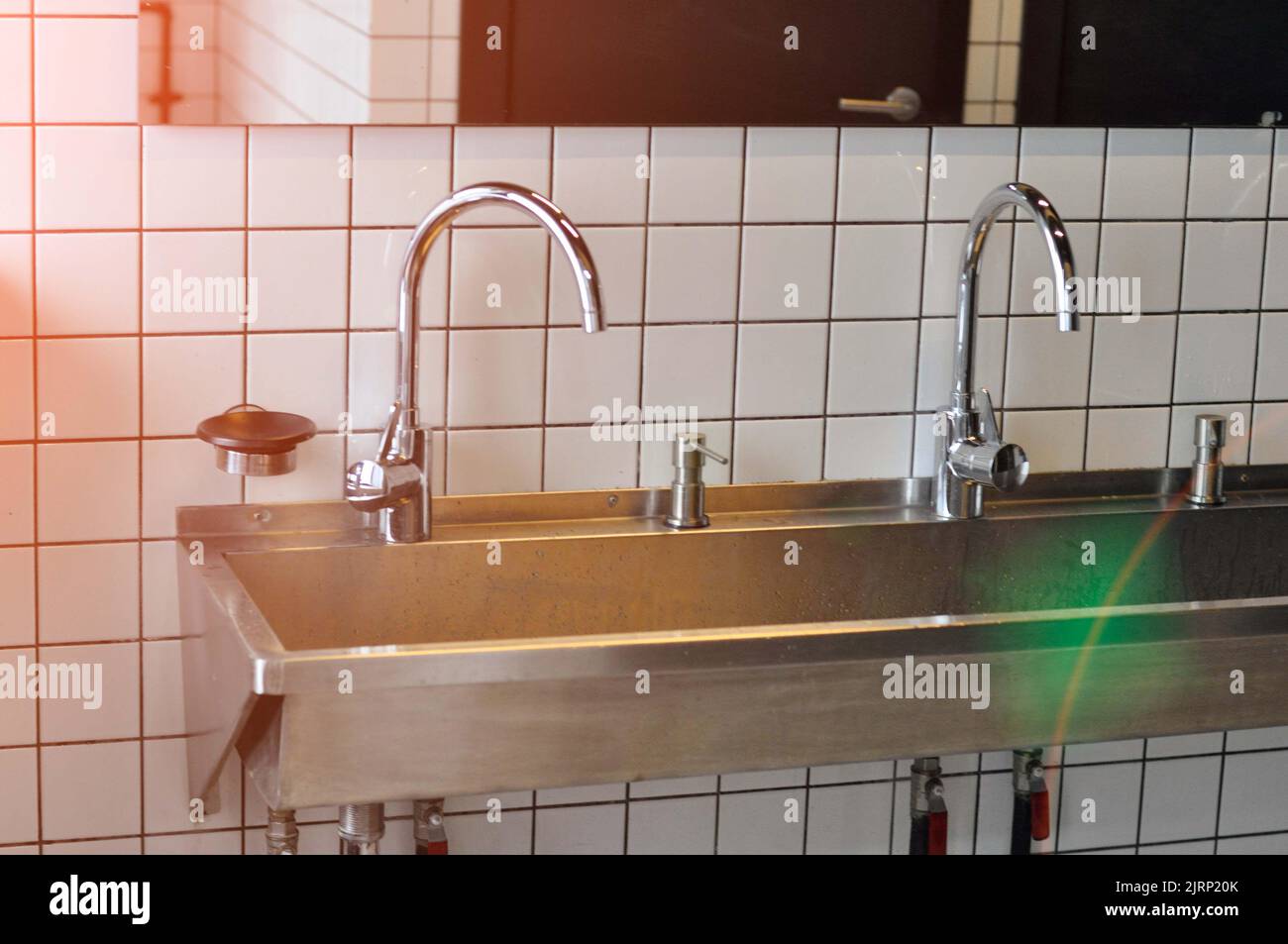 Stainless steel hand washing sink in a modern prison, lighting, tinting ...