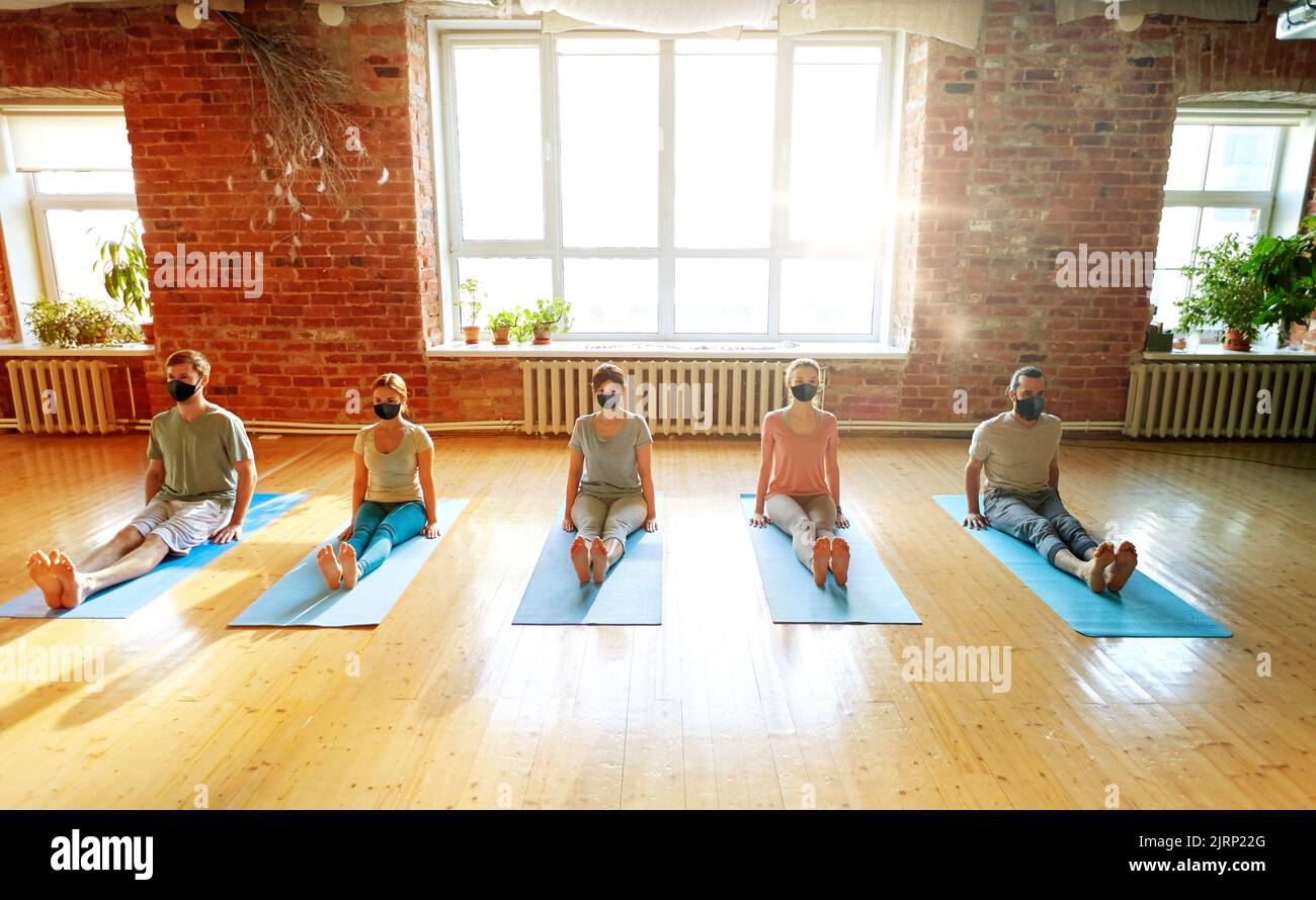 group of people doing yoga staff pose at studio Stock Photo - Alamy