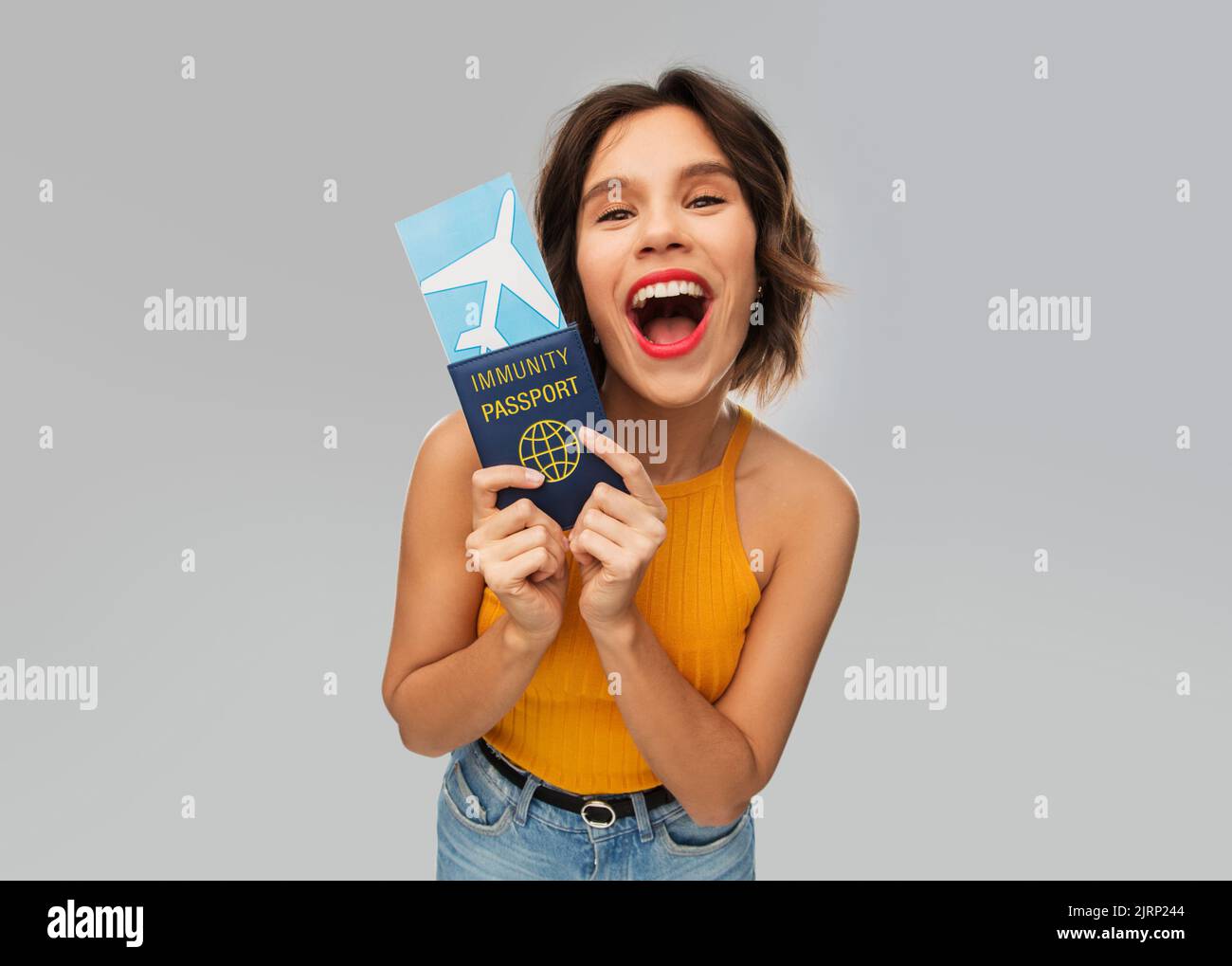 happy woman with air ticket and immunity passport Stock Photo - Alamy